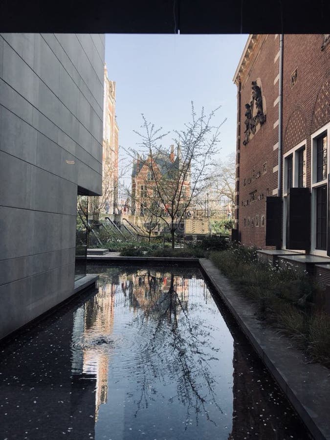 Serene Reflection Pool in Amsterdam Courtyard with Historic ...