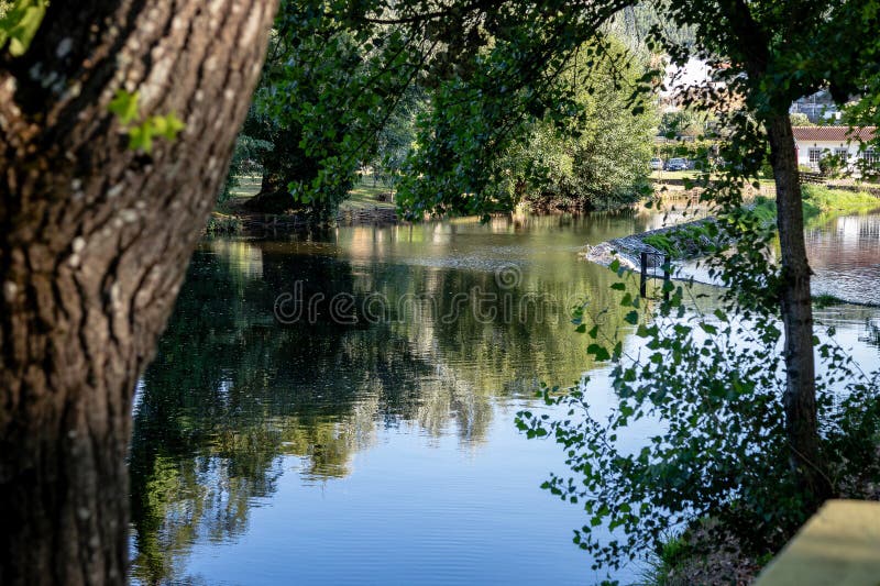 A Serene River Scene Featuring a Small Stone Dam with Water Gently ...