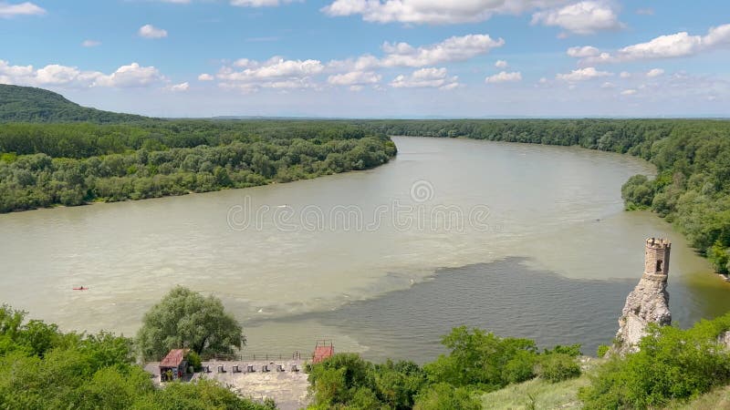A Serene Riverside Scene with Ancient Castle Ruins Perched on a ...