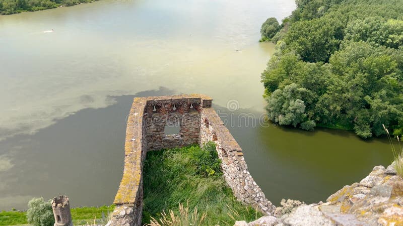 A Serene Riverside Scene with Ancient Castle Ruins Perched on a ...