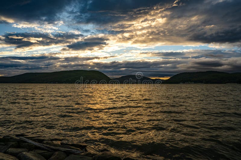 A Serene Sunset Over the Hudson River at Riverfront Green Park in ...