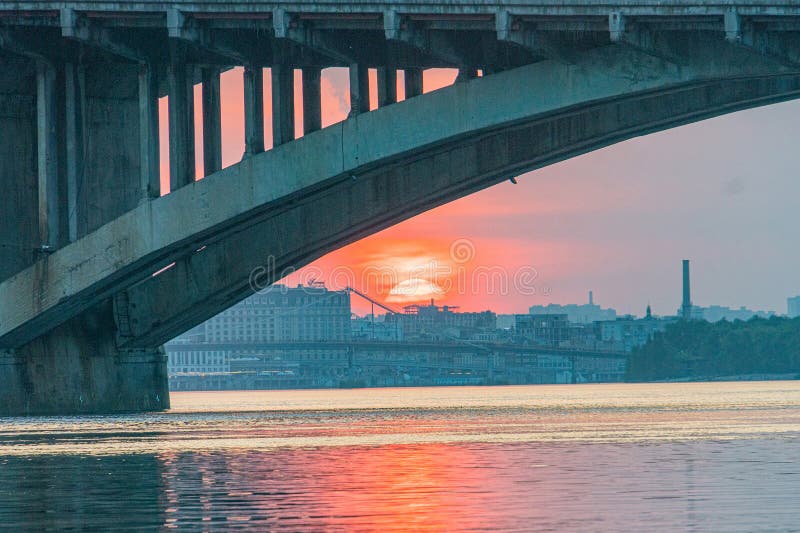 A Serene Sunset Scene of a Suspension Bridge and Waterfront the ...