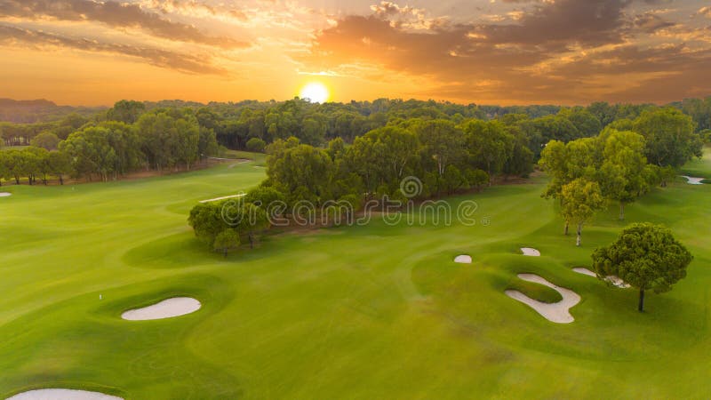 A Serene Sunset View of a Golf Course with Lush Greenery and Sand Traps ...