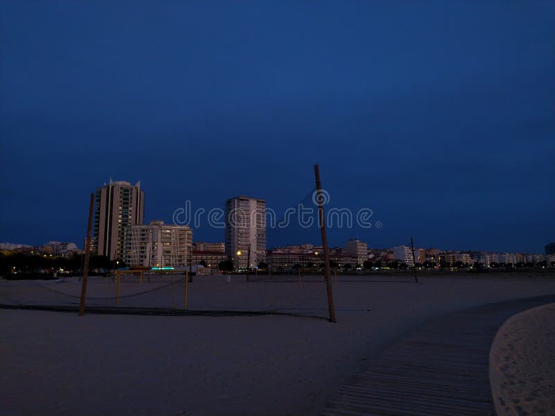Serene Twilight Scene on a Beach, Featuring an Empty Volleyball Net ...