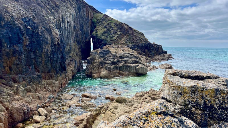 Serene View of a Beach with Clear Blue Ocean Water and Rocky Shoreline ...