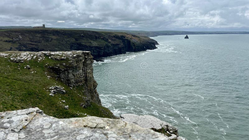 Serene View of a Beach with Clear Blue Ocean Water and Rocky Shoreline ...