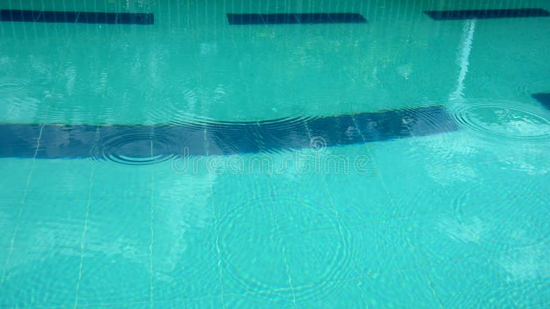 Blue Pool with Raindrops Creating Gentle Ripples on the Water S Surface ...