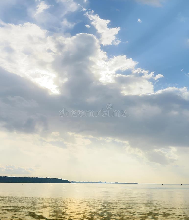 Calm Lake Under a Partly Cloudy Sky with Sunlight Reflections. Stock ...