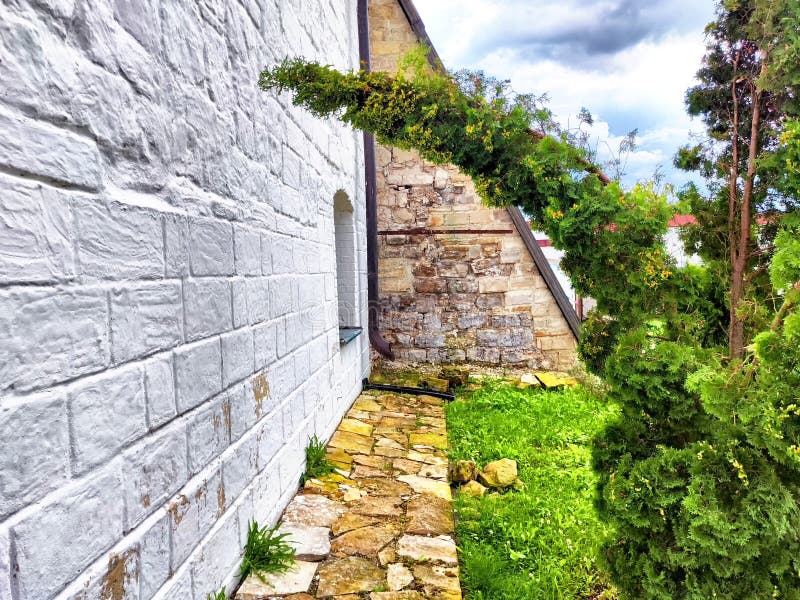 A Serene View of a Historic Building S Exterior with Greenery and Stone ...