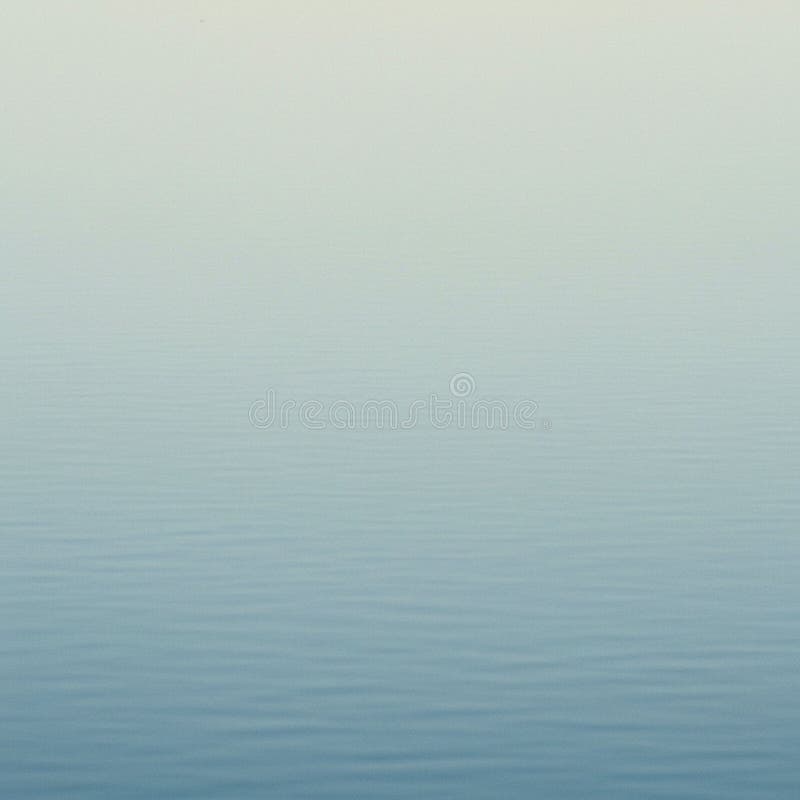A Serene Water Surface Showing a Subtle Gradient from Light Blue at the ...