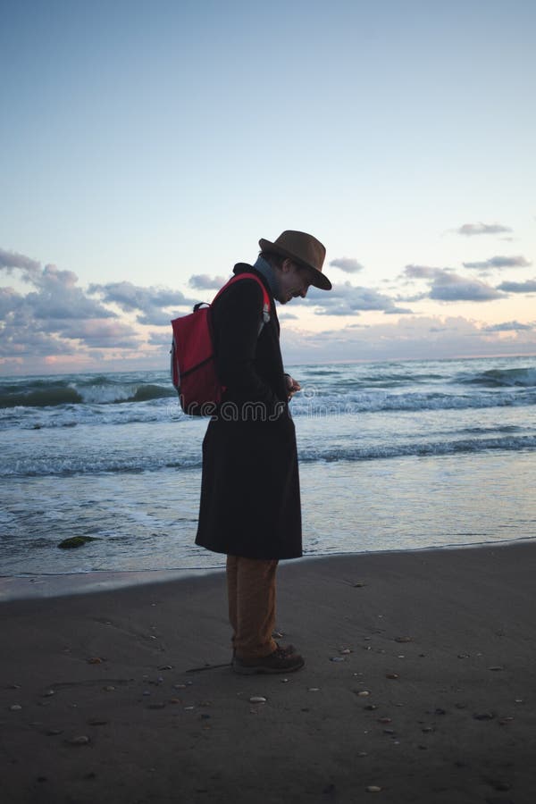 Serenity at Dusk Man Walks Along Tranquil Seashore. Stock Image - Image ...