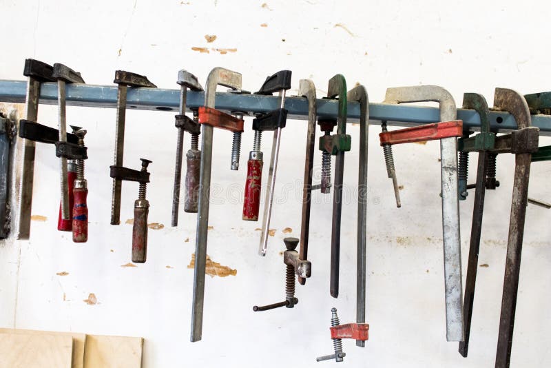Series of Carpenter Tools Hung in the Workshop. Clamps of Various Sizes ...