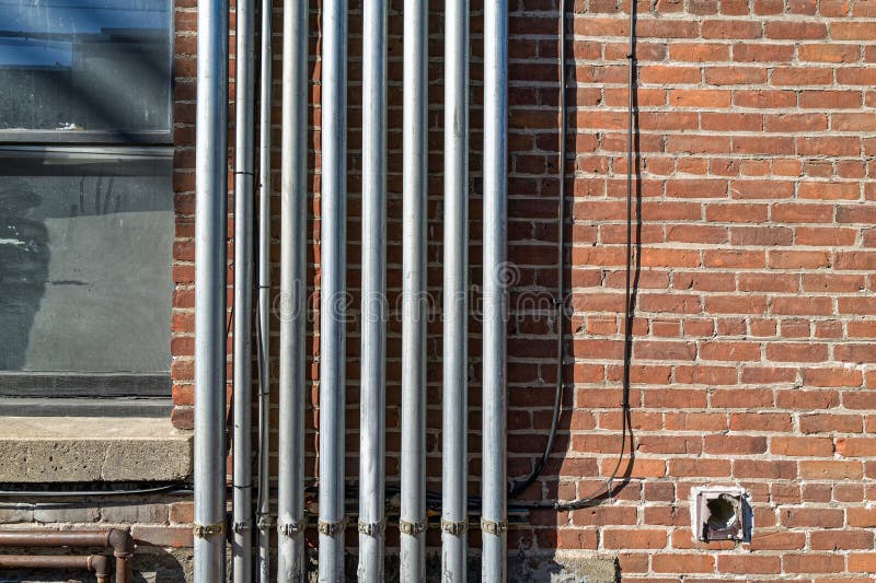 A Series of Metal Conduits Running Parallel Up and Down the Exterior ...