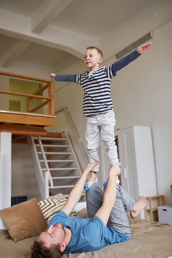 Practicing Acrobatic Exercise with Fathers Support Stock Photo - Image ...