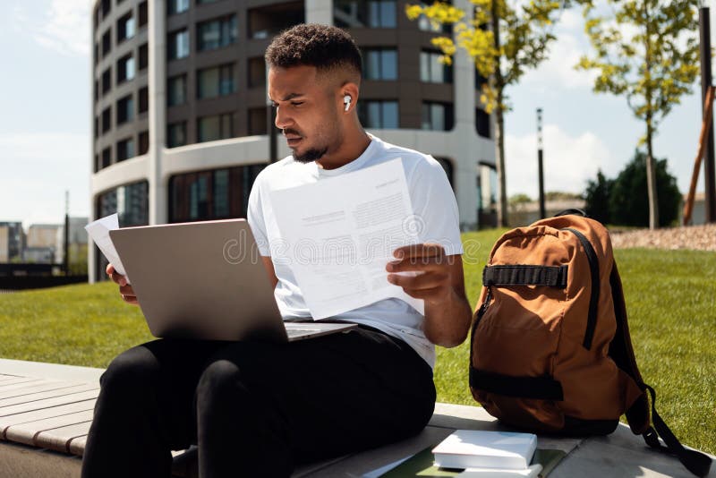 Serious African American Student Guy Using Laptop Computer Outdoors and ...