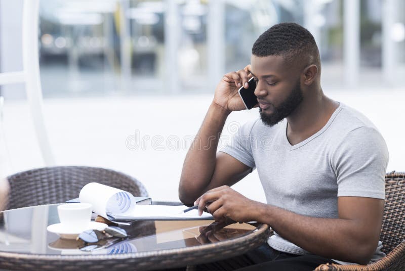 Serious African Man Checking Financial Plan Data with Collegues Stock ...