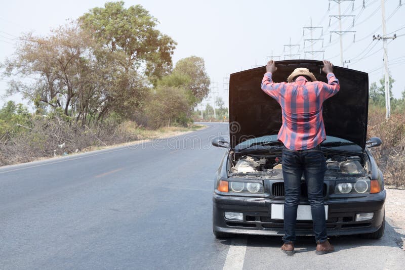 Serious African Man Looking at Engine of the Broken Car Stock Photo ...