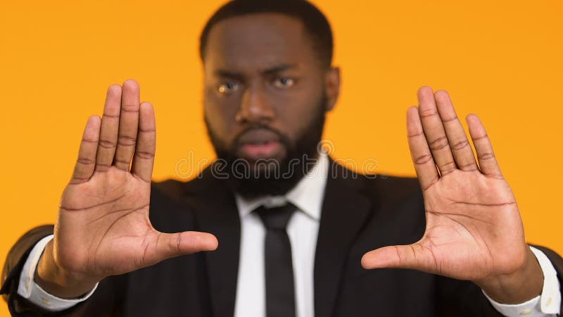 Serious Afro-American Business Man Showing Stop Gesture, Labor Rights ... Serious Afro-American Business Man Showing Stop Gesture, Labor Rights ...