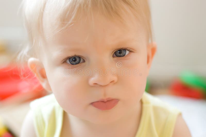 Serious baby girl face stock image. Image of blue, toys - 19882501