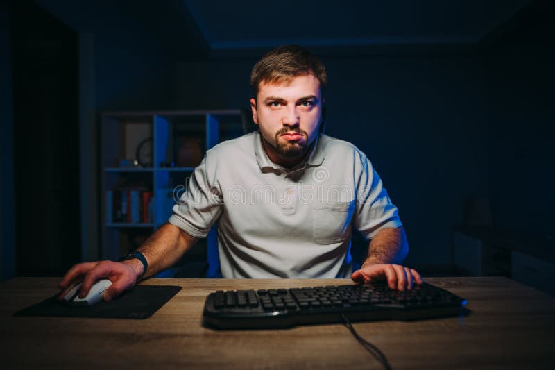 Serious Bearded Freelancer Works at Home on the Computer at Night and ...