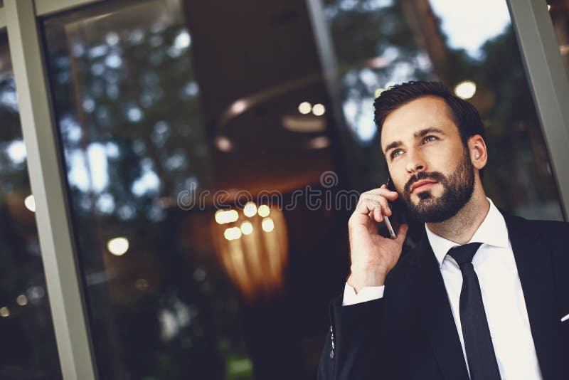 Serious Bearded Man Looking Calm while Talking on the Phone Stock Photo ...