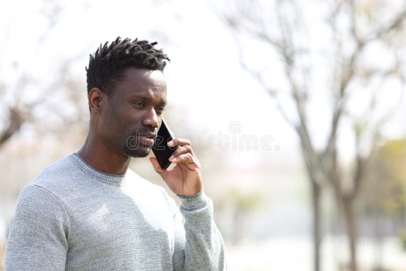 Serious Black Man Calling on Smart Phone at Park Stock Image - Image of ...