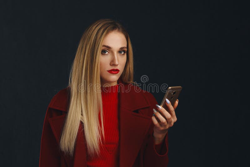 Serious Blond Woman Holding Phone and Watching Camera Isolated. Stock ...