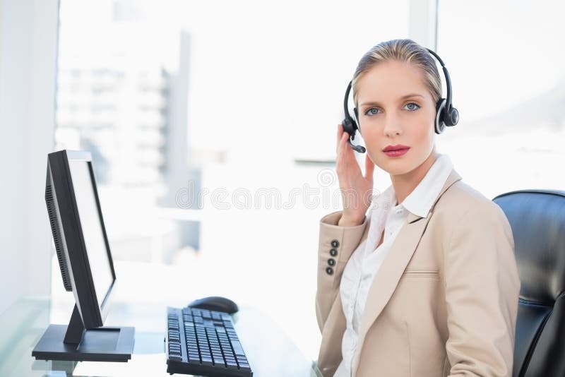 Serious Call Center Agent Looking at Camera while on a Call Stock Photo ...