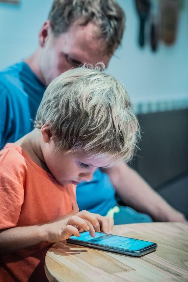 Serious Boy Interest Look in Smart Phone Study Map on Screen with ...