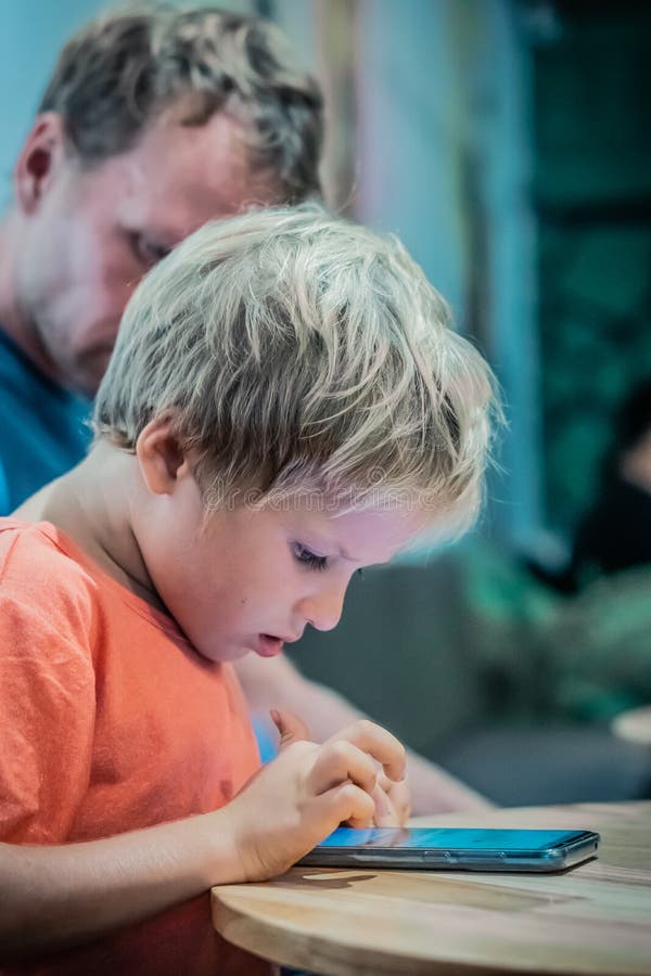 Serious Boy Interest Look in Smart Phone Study Map on Screen with ...