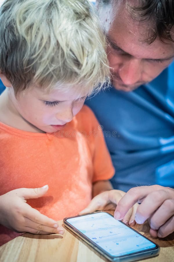 Serious Boy Interest Look in Smart Phone Study Map on Screen with ...