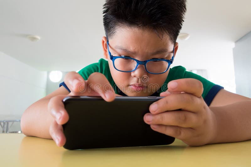 Serious Boy Playing on Smartphone Stock Image - Image of communication ...