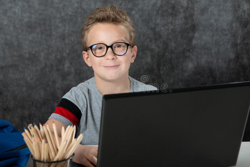 Serious Boy Sitting with Laptop Computer Stock Image - Image of ...