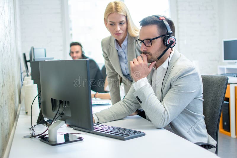 Serious Business Woman and Man Looking at the Computer Screen Together ...