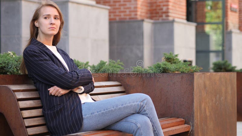 Serious Business Woman Sitting Outside Office and Looking Around Stock ... Serious Business Woman Sitting Outside Office and Looking Around Stock ...