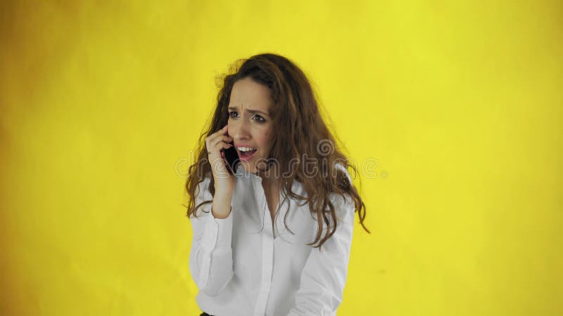 Serious Business Woman Talking Mobile Phone On Yellow Background