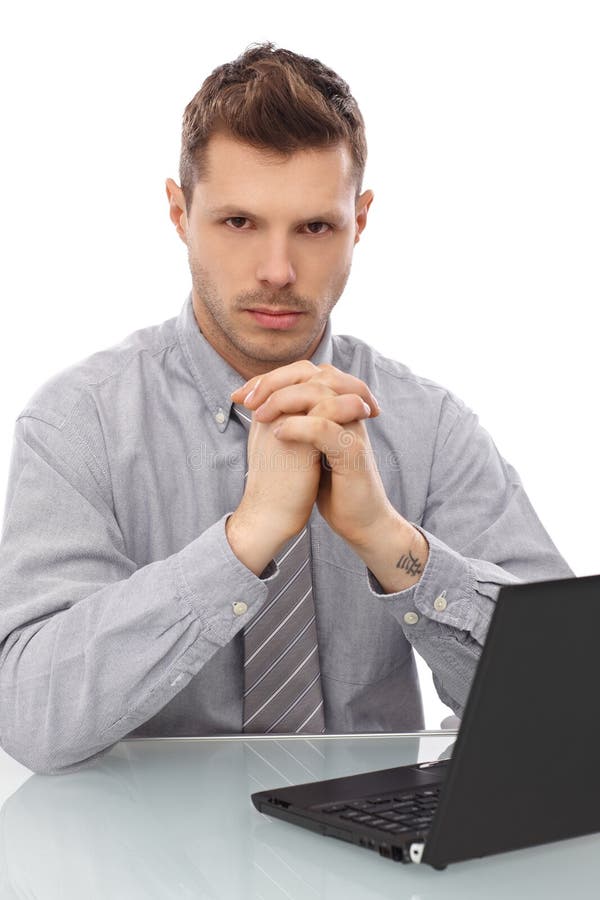 Serious Businessman Sitting at Desk Stock Image - Image of camera ...