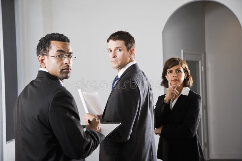 Serious Businesspeople Looking Over Shoulder Stock Photo - Image of ...