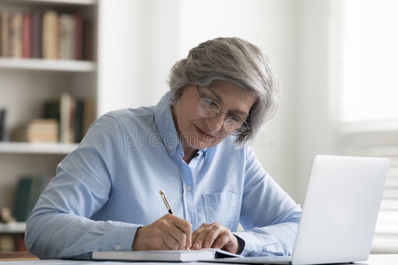 Serious Busy Mature Lady Working at Laptop Computer Stock Image - Image ...