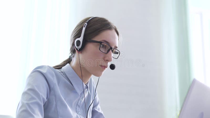 Serious Call Center Operator in Wireless Headset Talking with Customer ...
