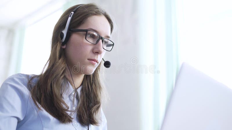 Serious Call Center Operator in Wireless Headset Talking with Customer ...