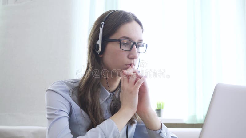 Serious Call Center Operator in Wireless Headset Talking with Customer ...