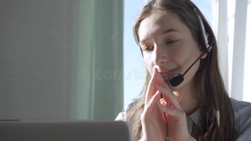 Serious Call Center Operator in Wireless Headset Talking with Customer ...