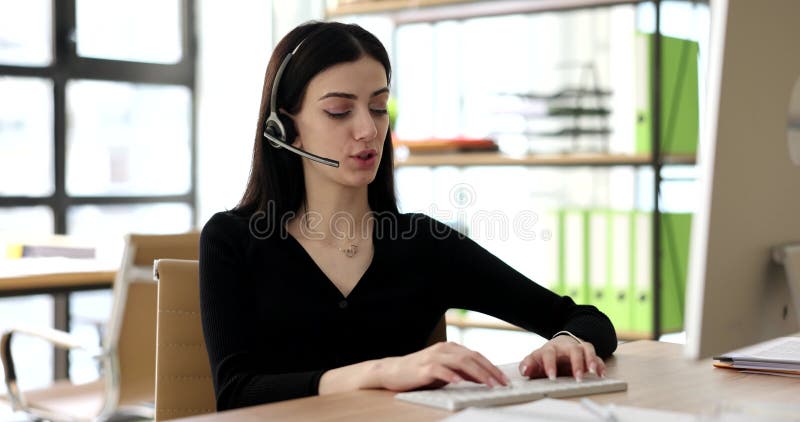 Serious Call Center Operator in Wireless Headset Talking To Client ...