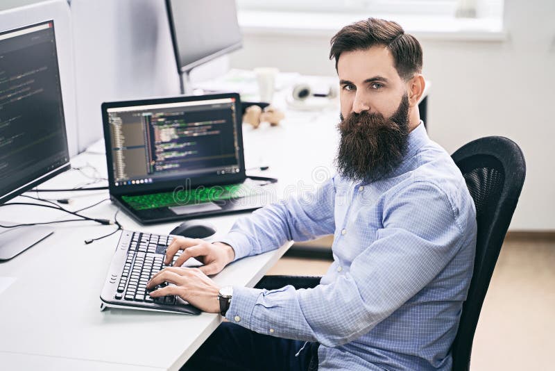 Closeup Portrait Of A Serious Computer Programmer Developer Working In It Office Sitting At