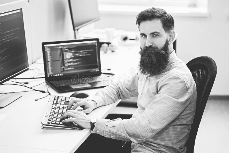 Computer Programmer Developer Working In It Office Sitting At Desk And Coding Working On A