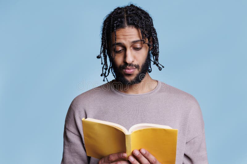 Serious Concentrated Arab Man Reading Book and Thinking Stock Photo ...