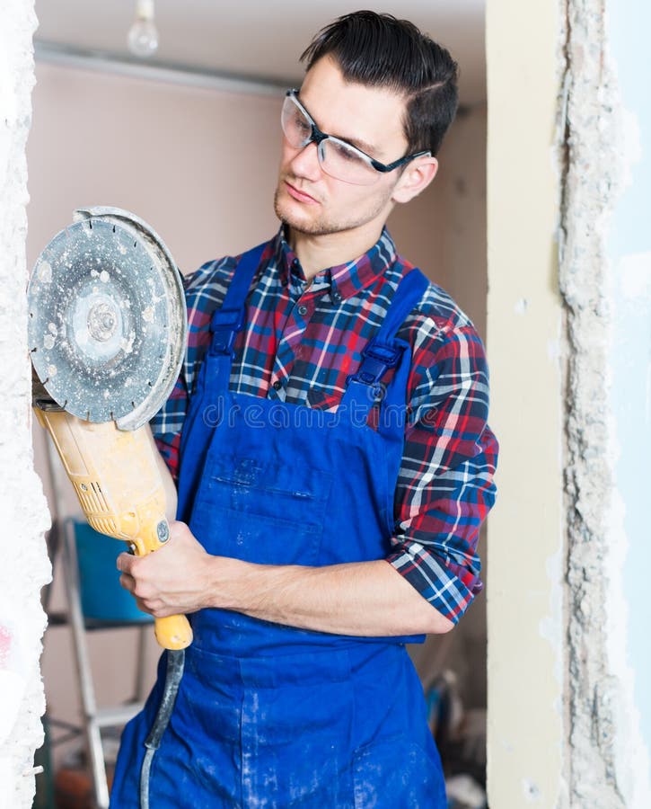 Serious Construction Worker Cutting Concrete Wall by Using Handheld ...