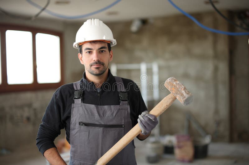 Serious Construction Worker Posing with Hammer Stock Photo - Image of ...