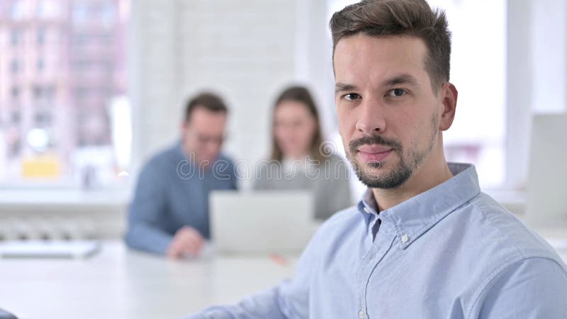 Serious Creative Man Looking at the Camera in Office Stock Photo ...